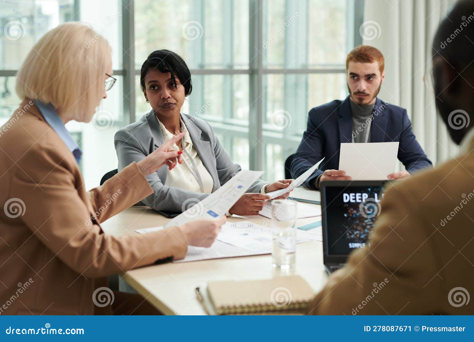 Blond Female Boss with Financial Document Explaining Something To ...