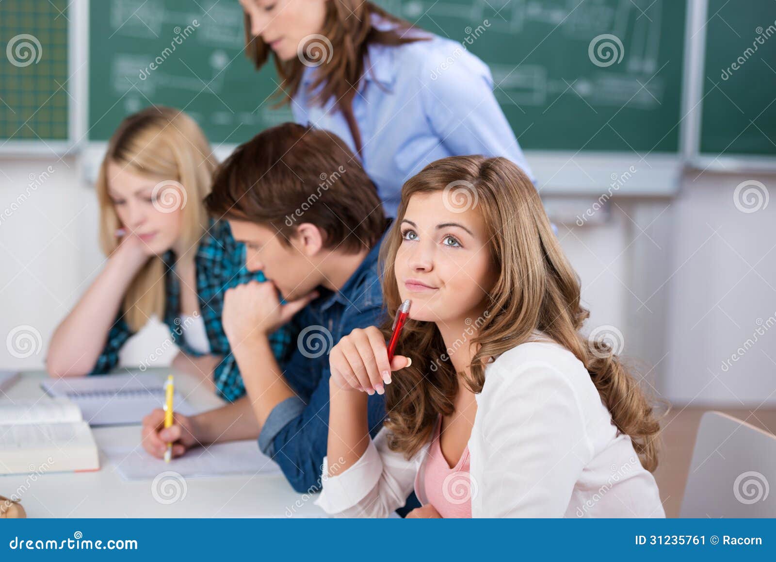Blond Female Student with Classmates at Desk Stock Image - Image of ...