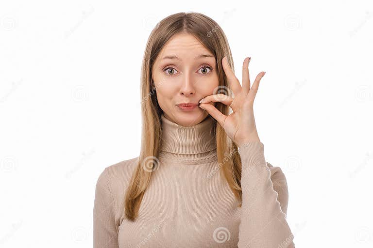 Blond Girl In Casual Clothes Showing Zip Gesture As If Shutting Mouth