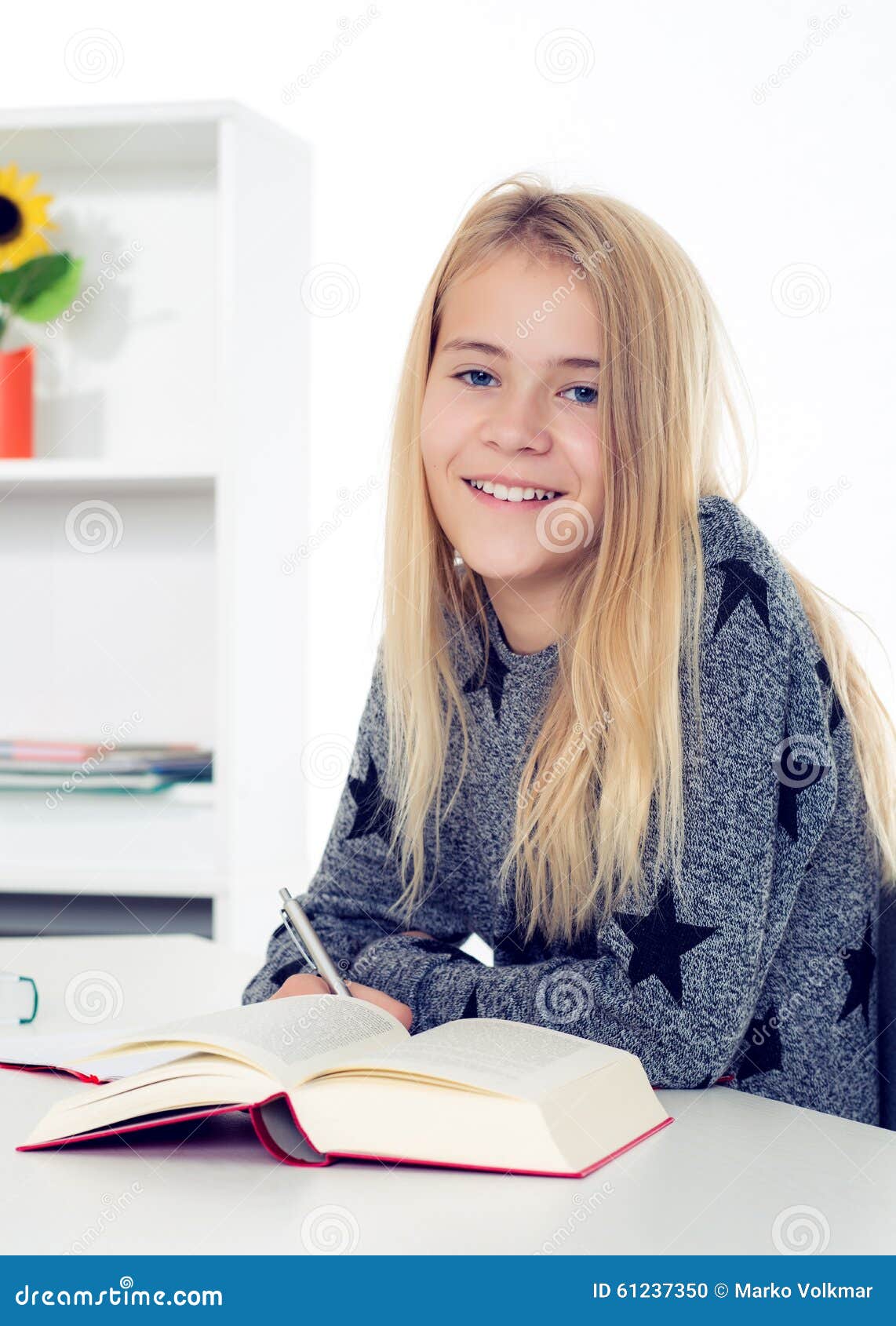 Blond girl doing homework stock photo. Image of classroom - 61237350