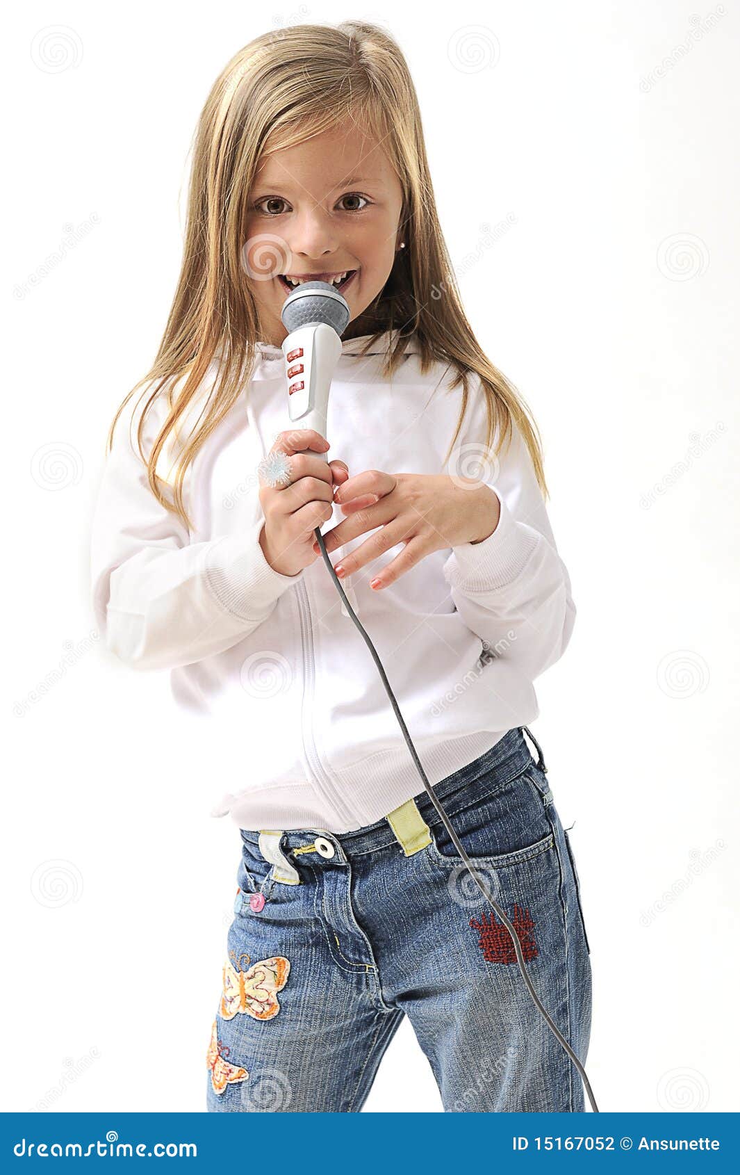 Blond Girl Singing Using a Microphone Stock Photo - Image of jeans ...