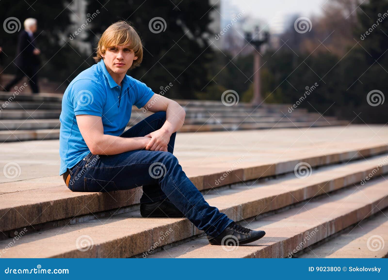 Blond man sitting outdoors stock photo. Image of lifestyle - 9023800