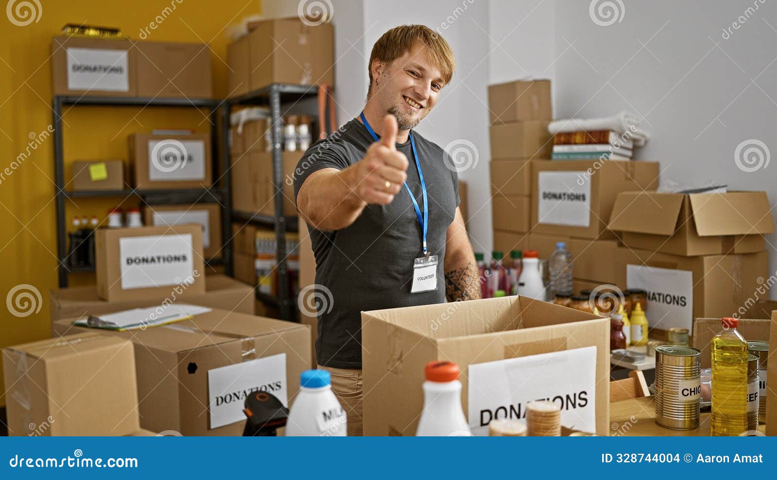 Blond Man Volunteering Sorting Donations in the Storeroom Giving Thumbs ...