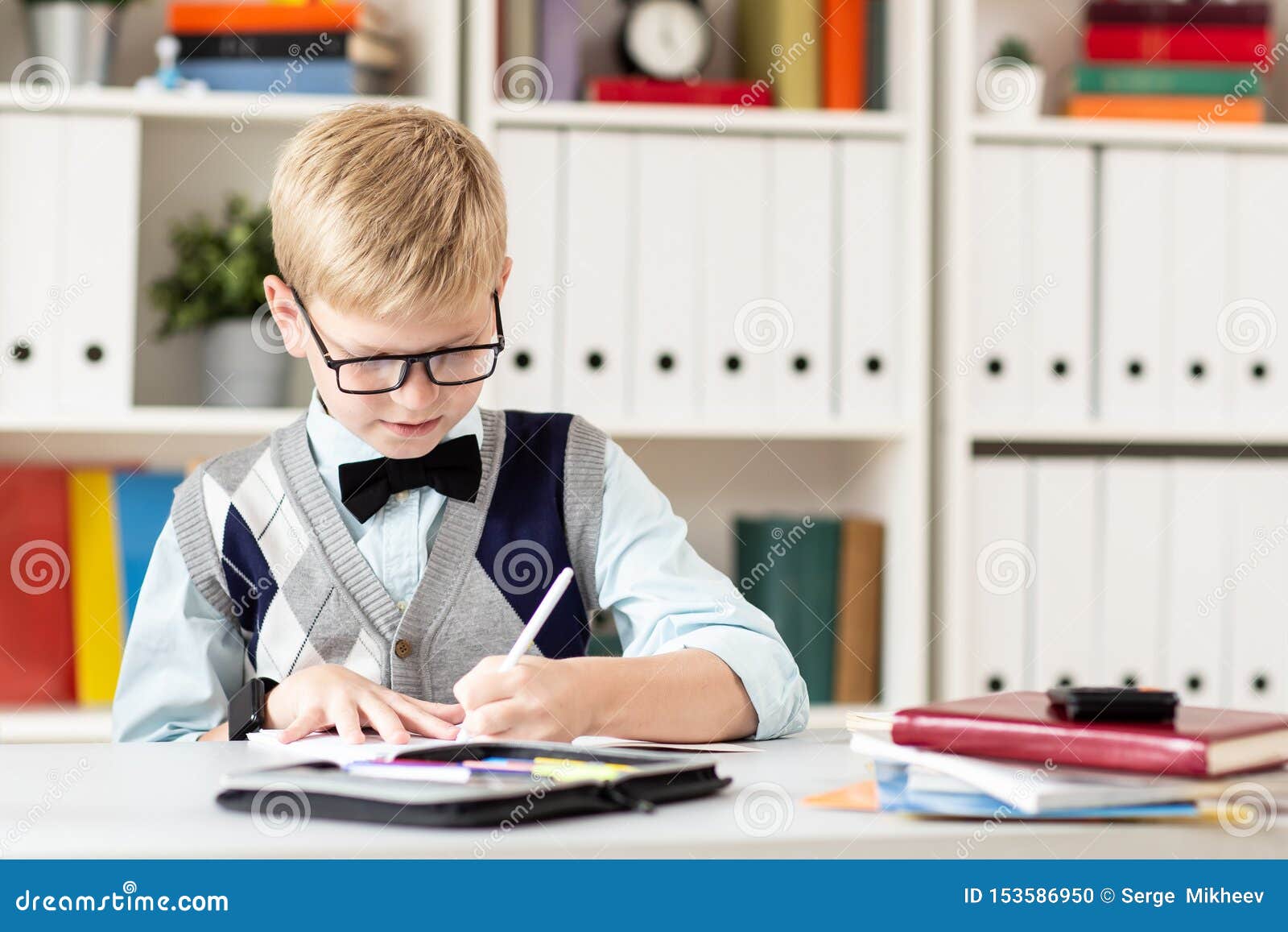 Blond Schoolboy in a Sweater Doing a Classwork Stock Photo - Image of ...