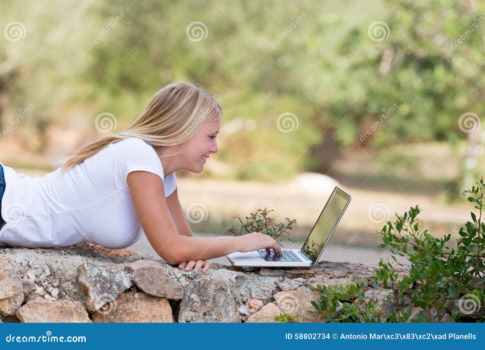 Blond Teenager Using Laptop Outdoor Stock Photo - Image of focus ...