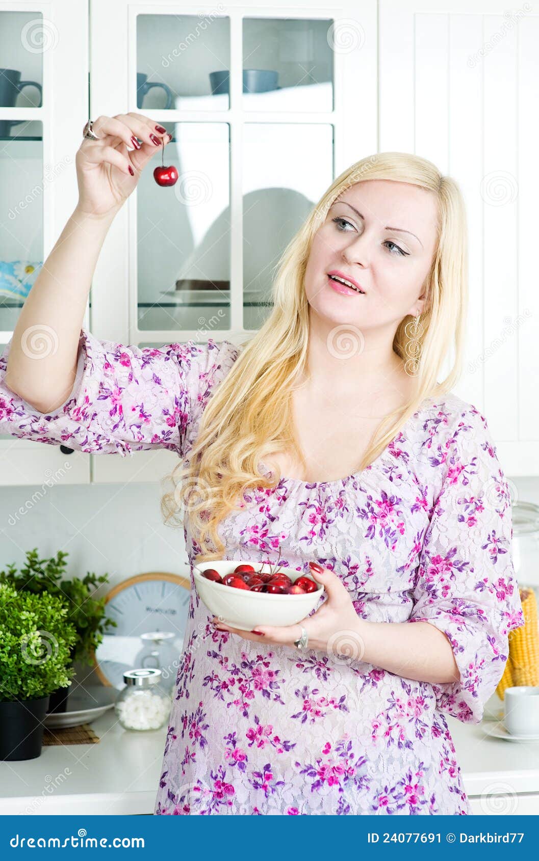 Blond woman eating cherry stock image. Image of beautiful - 24077691