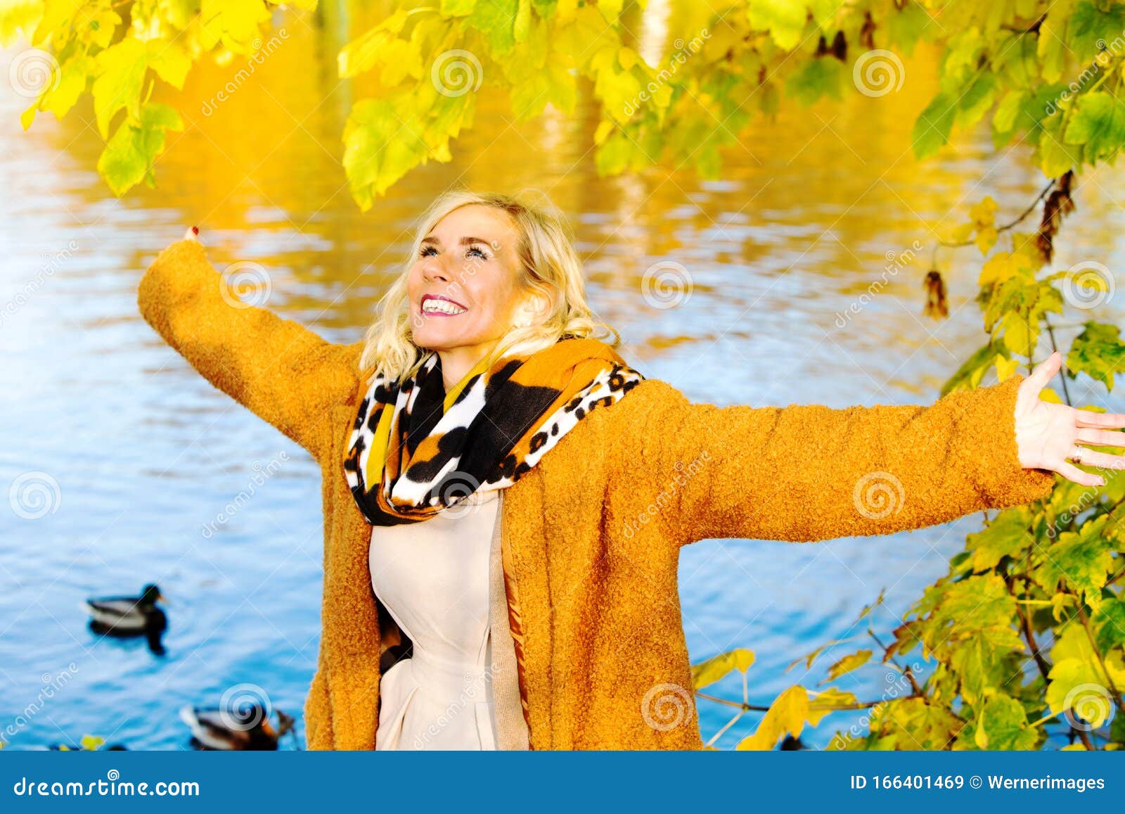Blond Woman Spreading Her Arms And Enjoying The Autumn Sun Stock Image Image Of People Leaves