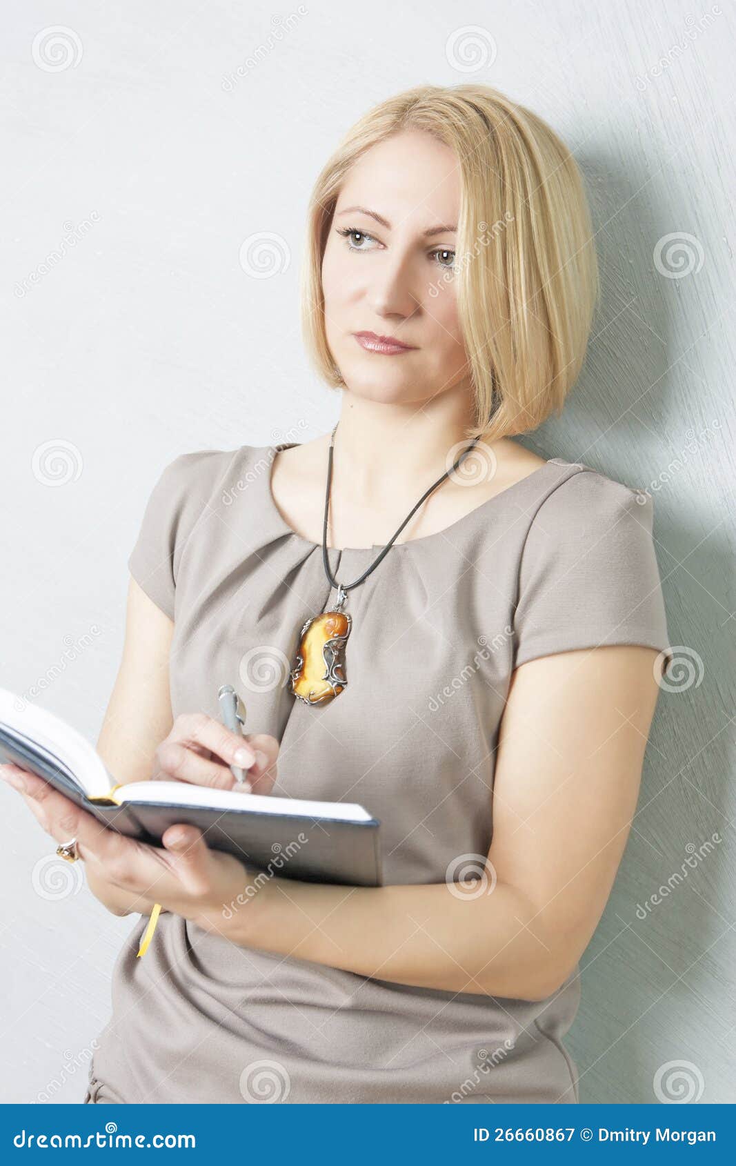Blond woman making notes stock image. Image of notes - 26660867