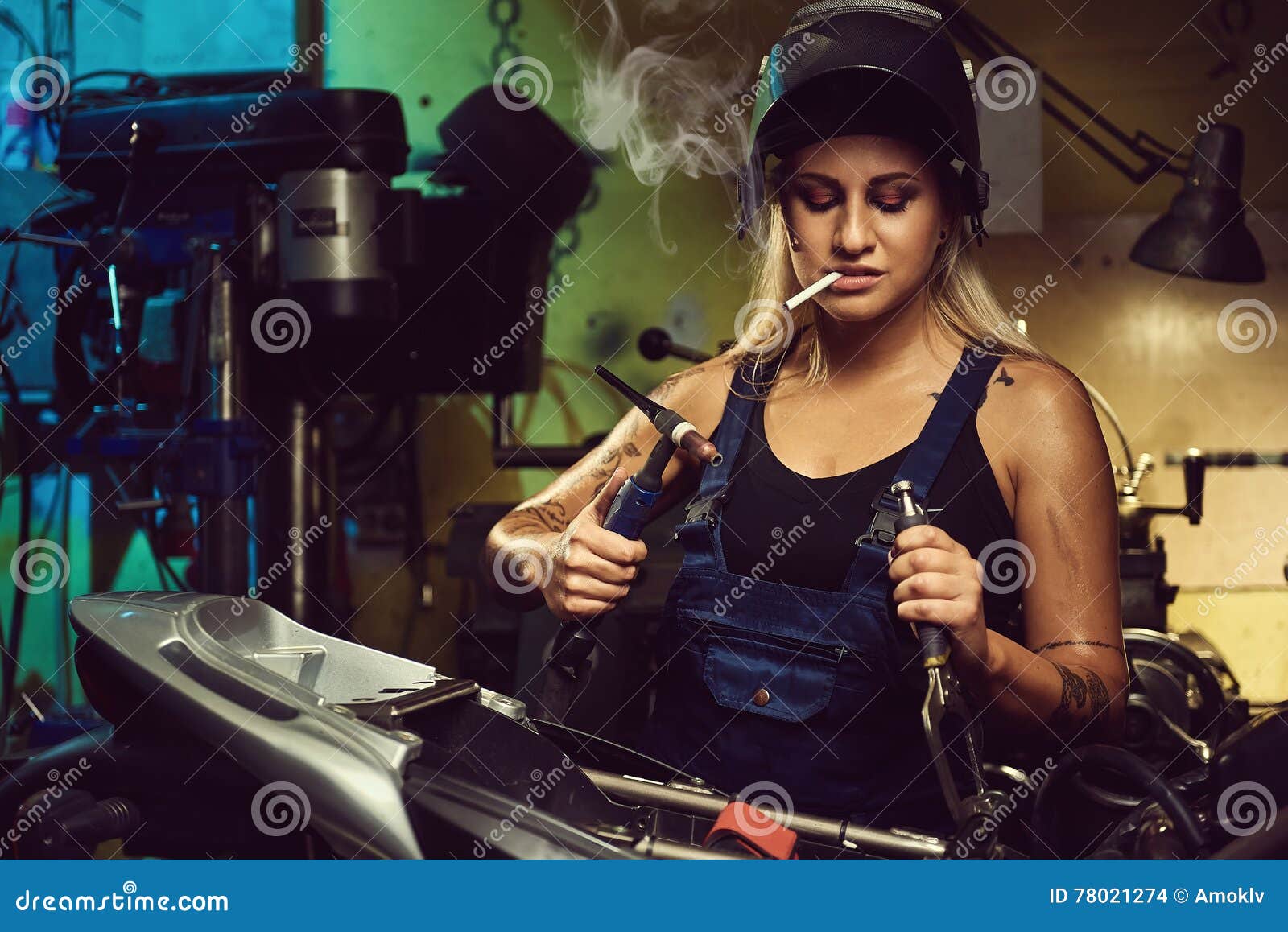 Blond woman mechanic stock photo. Image of moto, indoors - 78021274