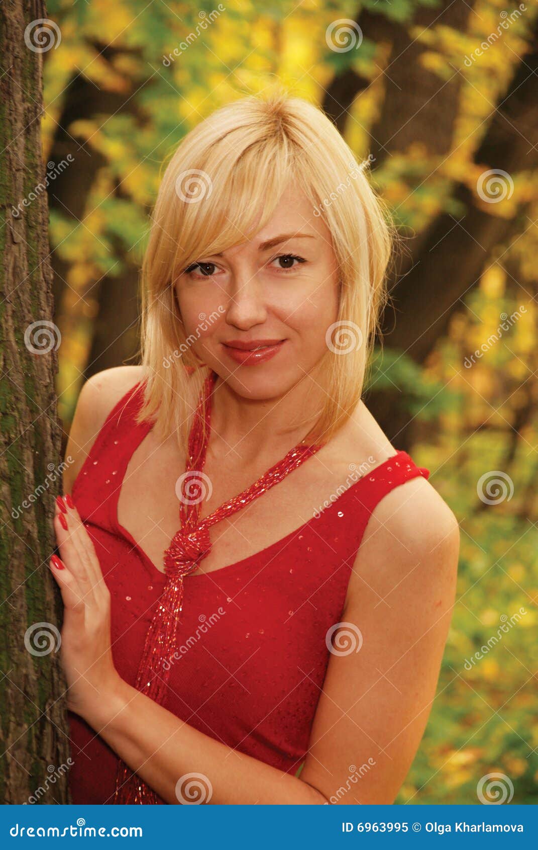 Blond Woman in Red is by a Tree Stock Image - Image of fingers, hair ...