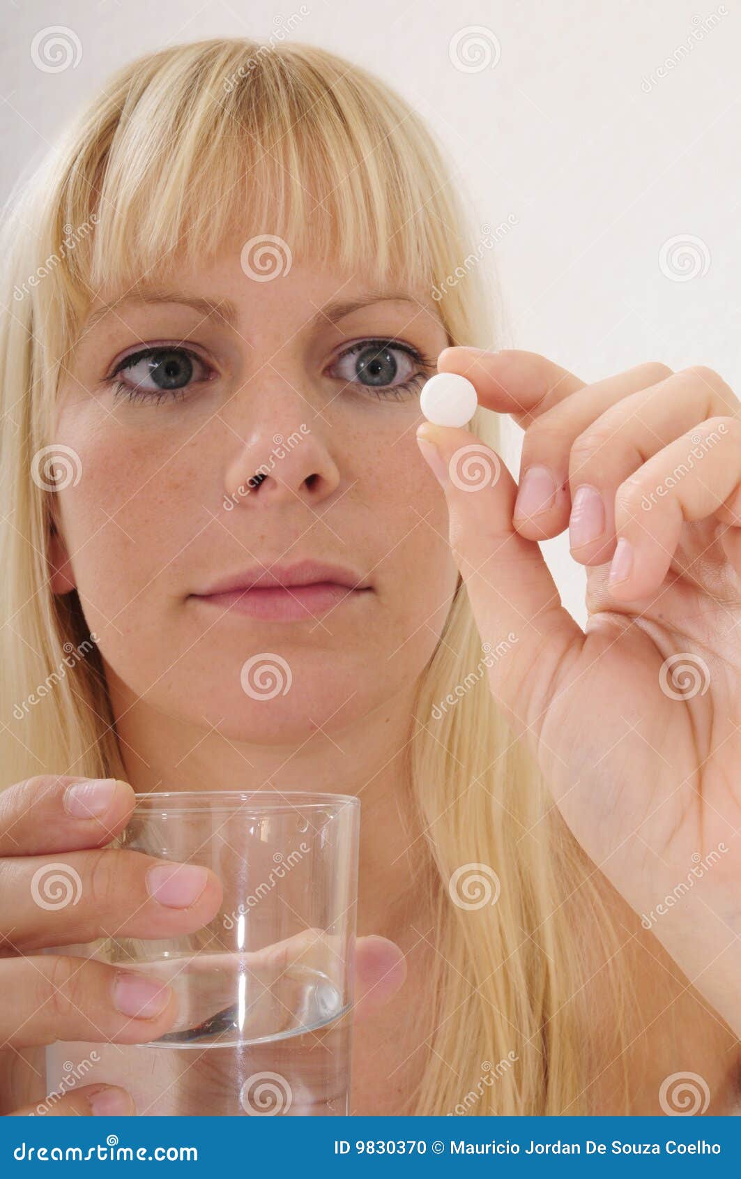 Blond woman taking a pill stock photo. Image of headache - 9830370