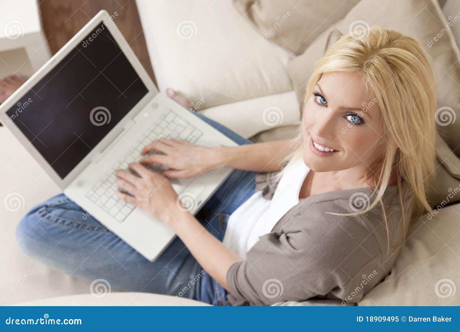 Blond Woman Using Laptop Computer at Home on Sofa Stock Image - Image ...