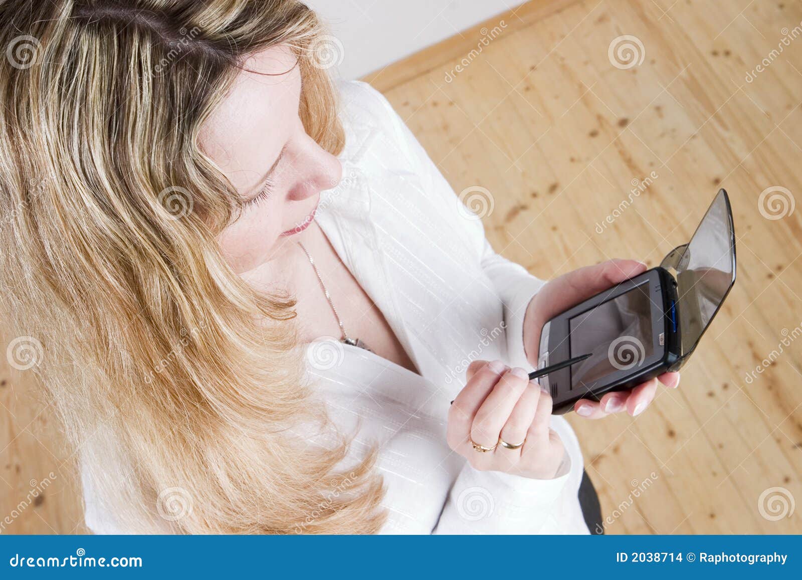A blond woman using a pda. stock photo. Image of caucasian - 2038714