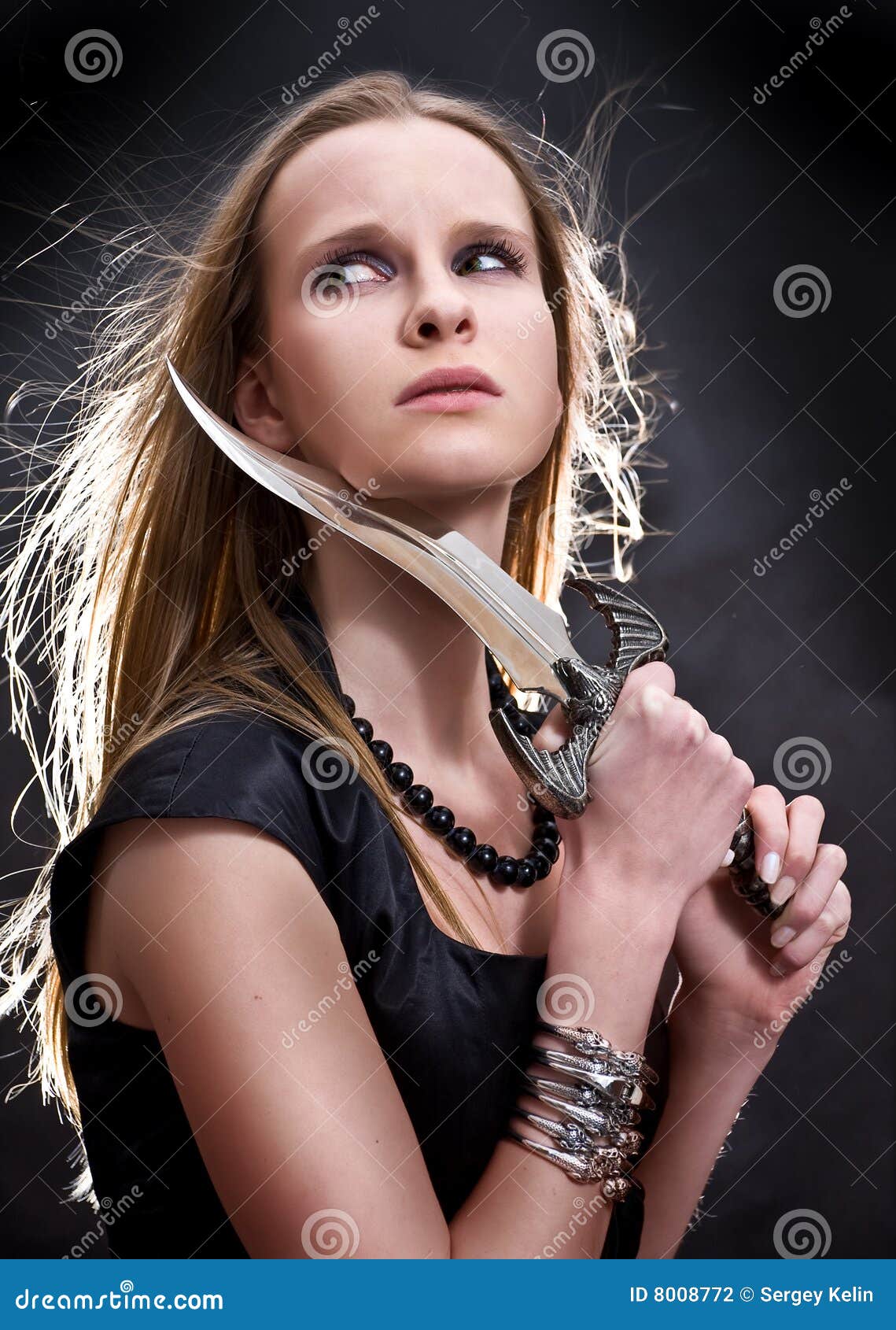 Blond Young Girl Holding Dagger Stock Photo - Image of hand, bracelet ...