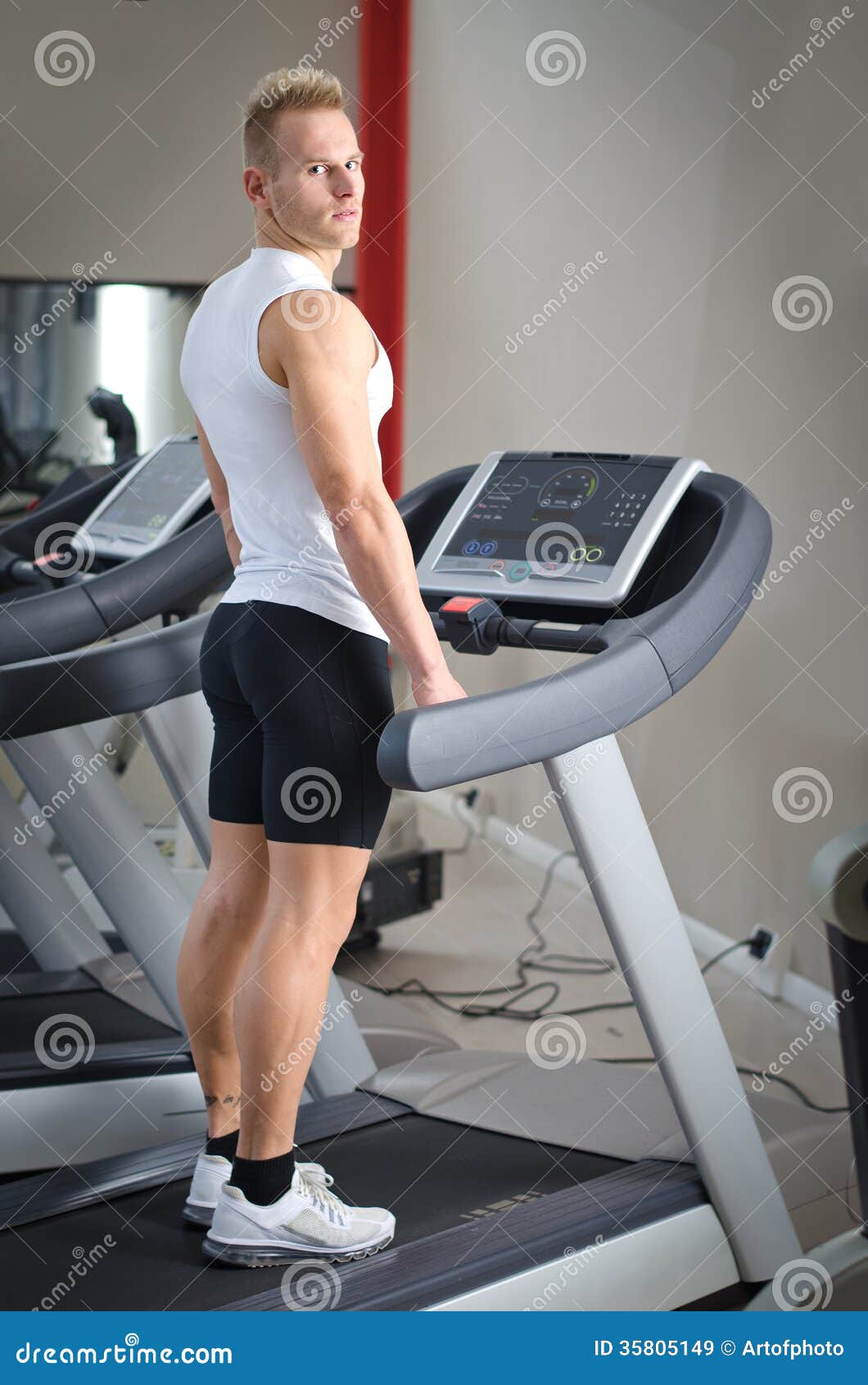 Blond Young Man Standing on Treadmill Stock Image - Image of running ...