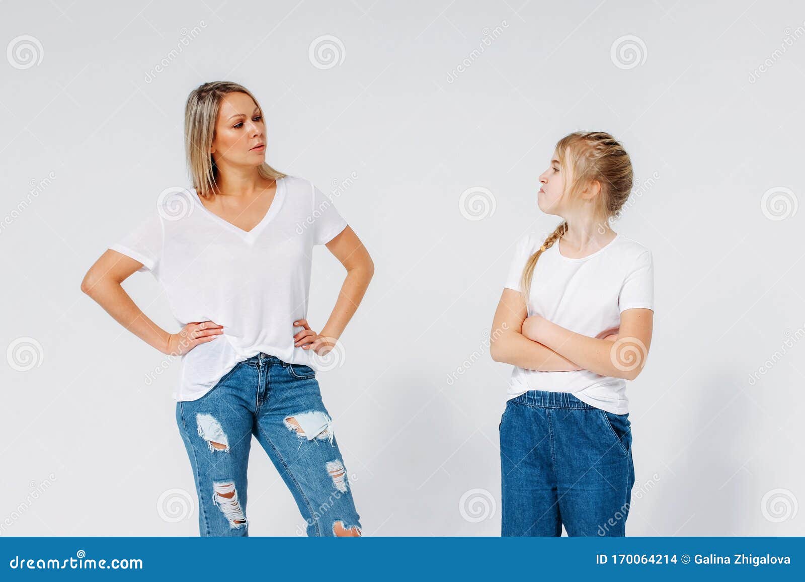 Blonde Angry Mom And Sad Daughter In White T Shirts And Jeans Isolated
