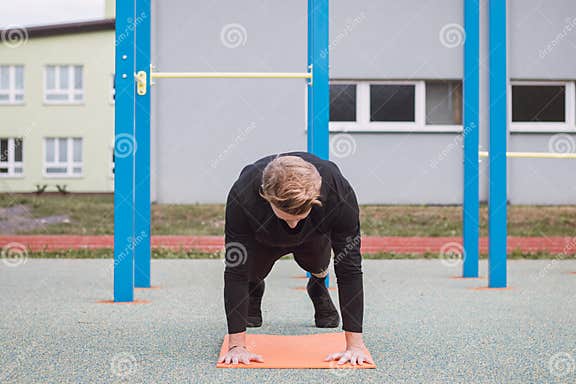 Blonde Athlete Performs an Exercise Called a Push-up. a Heavy Intense ...