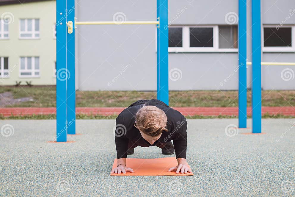 Blonde Athlete Performs an Exercise Called a Push-up. a Heavy Intense ...