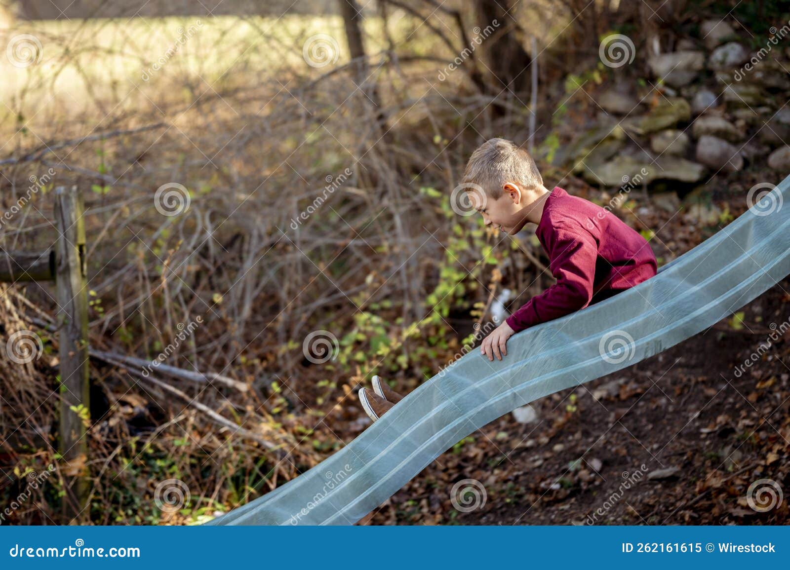 Blonde Boy Sliding Down a Playground Slide Stock Image - Image of ...