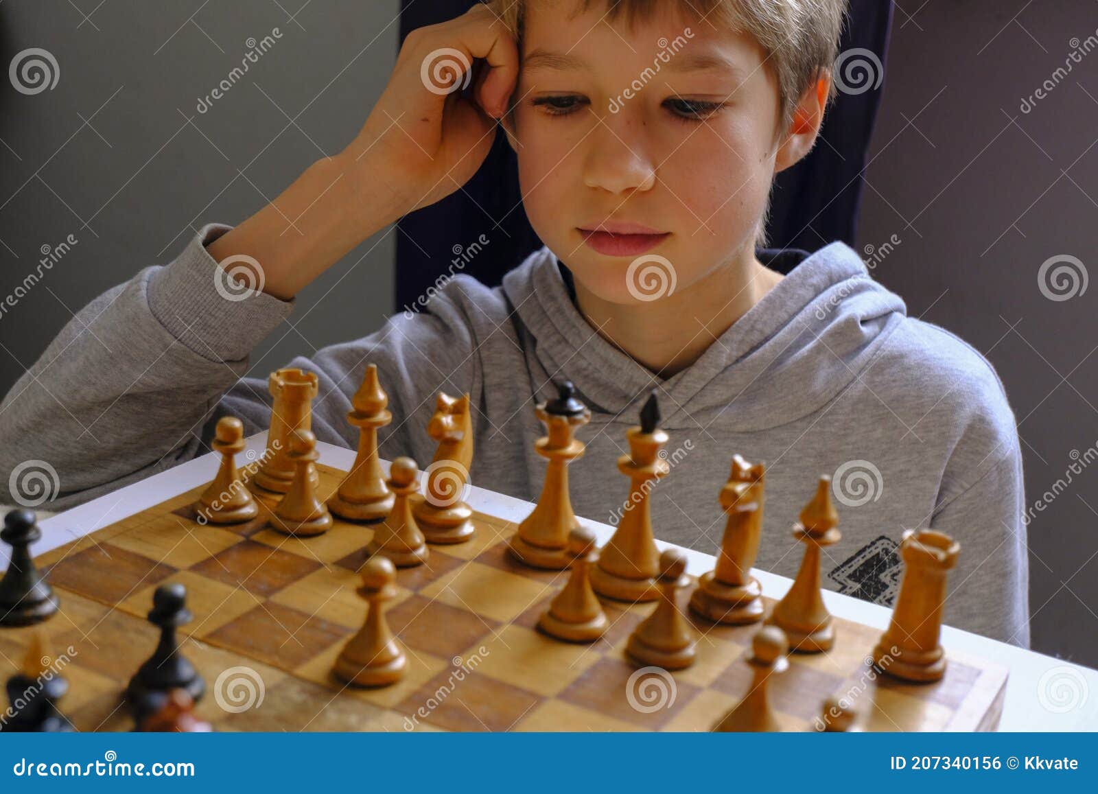 Blonde Caucasian Boy Thinking of a Next Chess Move Playing Chess ...