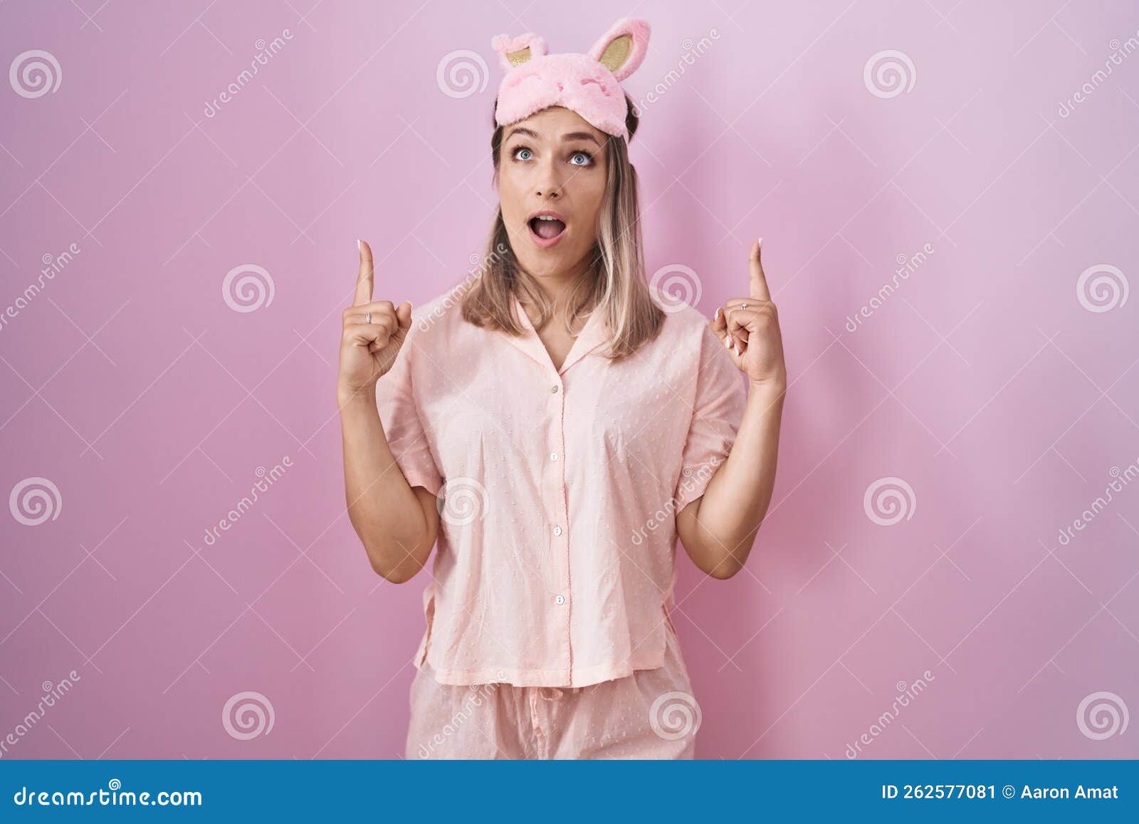 Blonde Caucasian Woman Wearing Sleep Mask And Pajama Amazed And