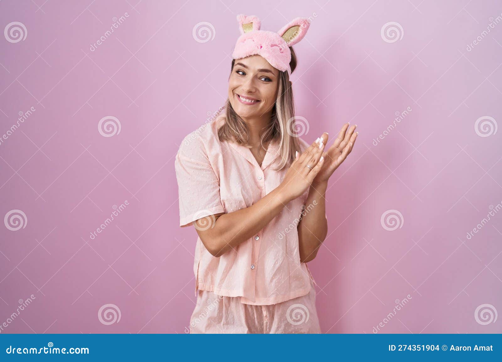 Blonde Caucasian Woman Wearing Sleep Mask And Pajama Clapping And