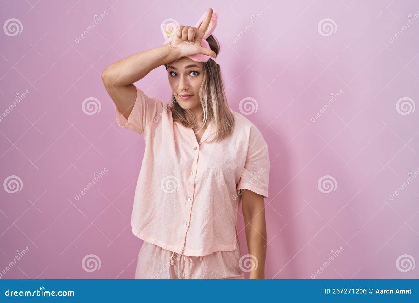 Blonde Caucasian Woman Wearing Sleep Mask And Pajama Making Fun Of