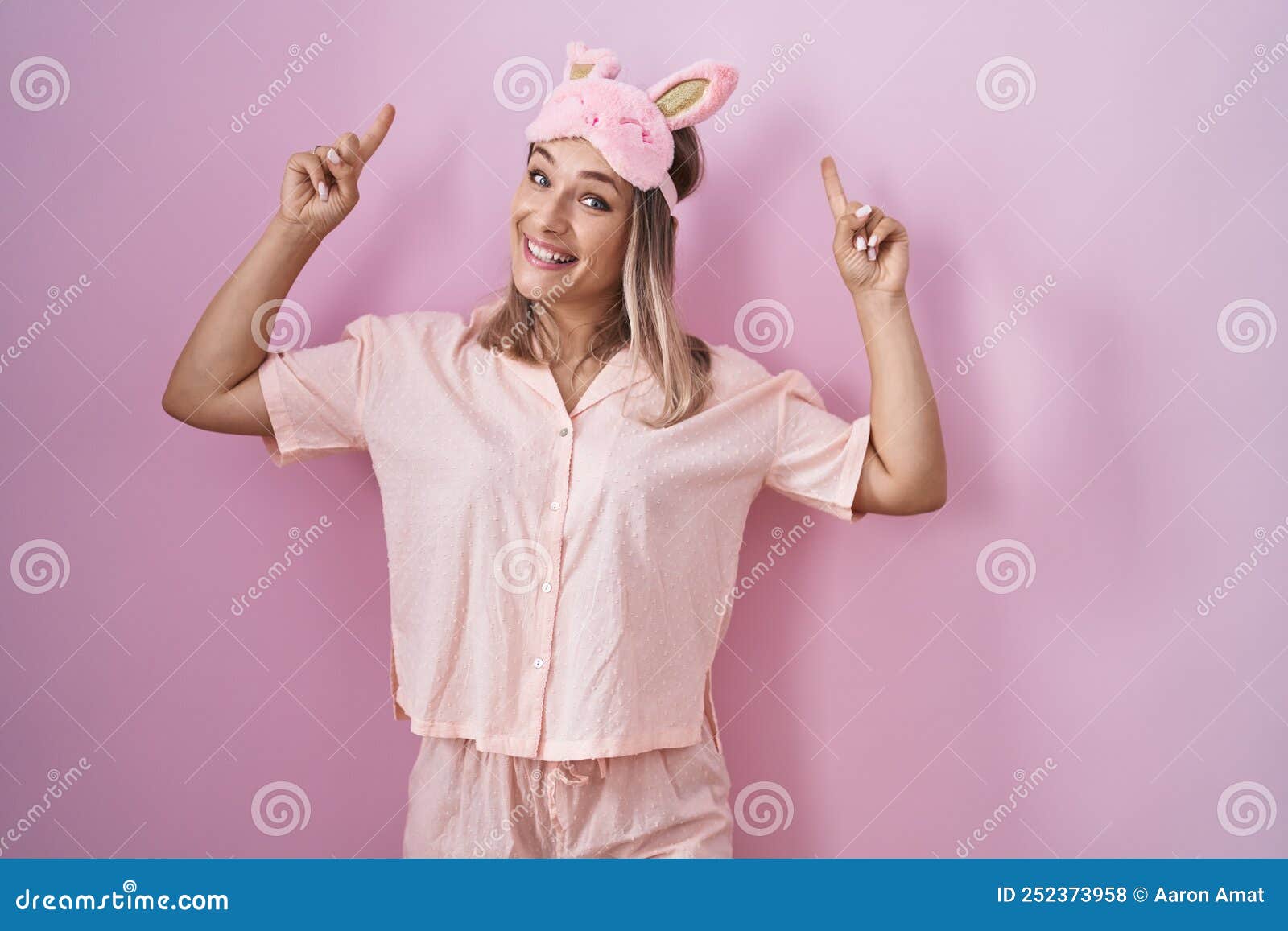 Blonde Caucasian Woman Wearing Sleep Mask And Pajama Smiling Amazed And