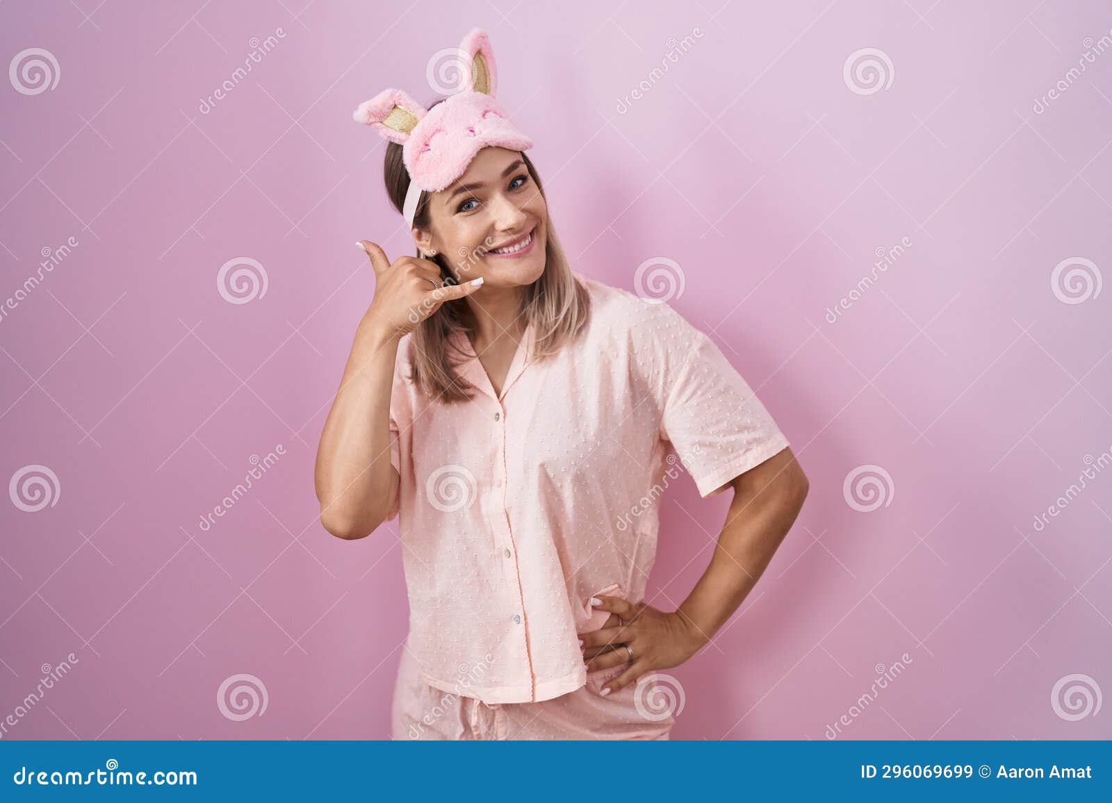 Blonde Caucasian Woman Wearing Sleep Mask And Pajama Smiling Doing