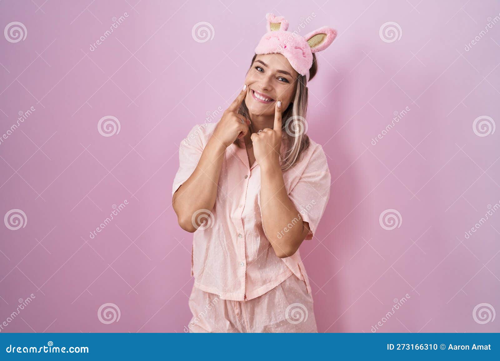 Blonde Caucasian Woman Wearing Sleep Mask And Pajama Smiling With Open