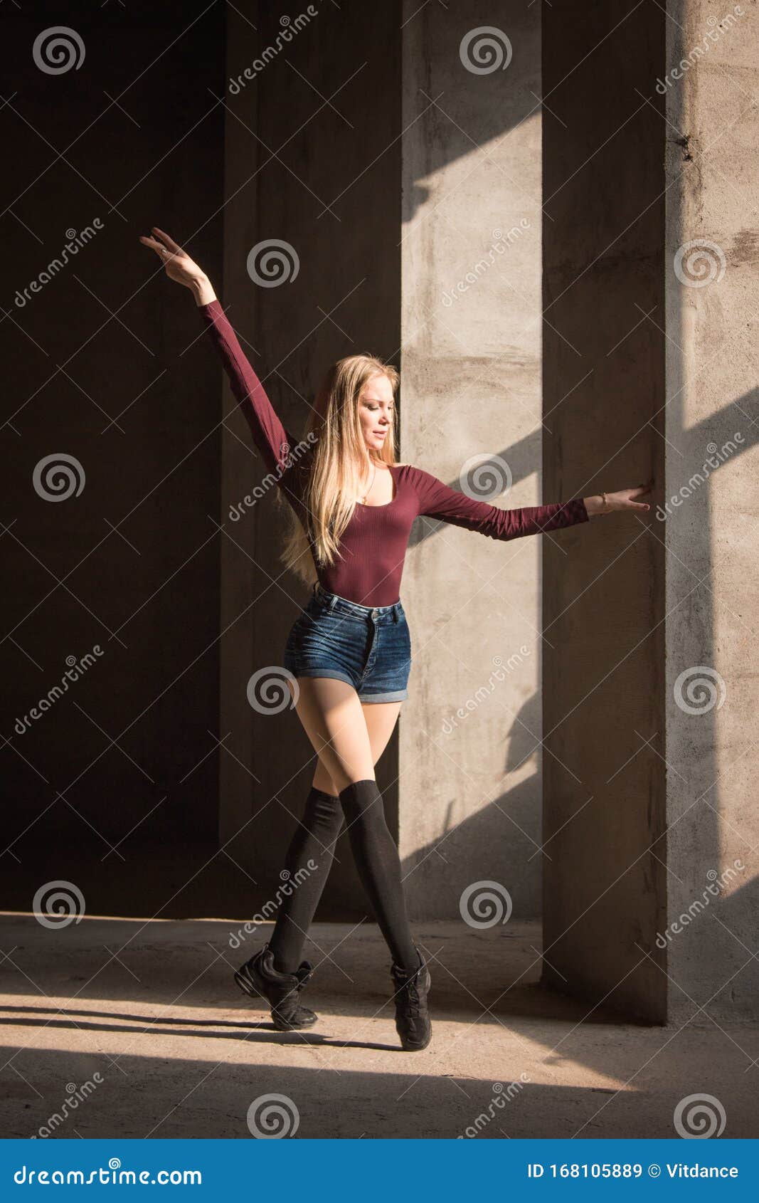Blonde Dancer Stands On Fingers On A Gray Background Sunlight Stock