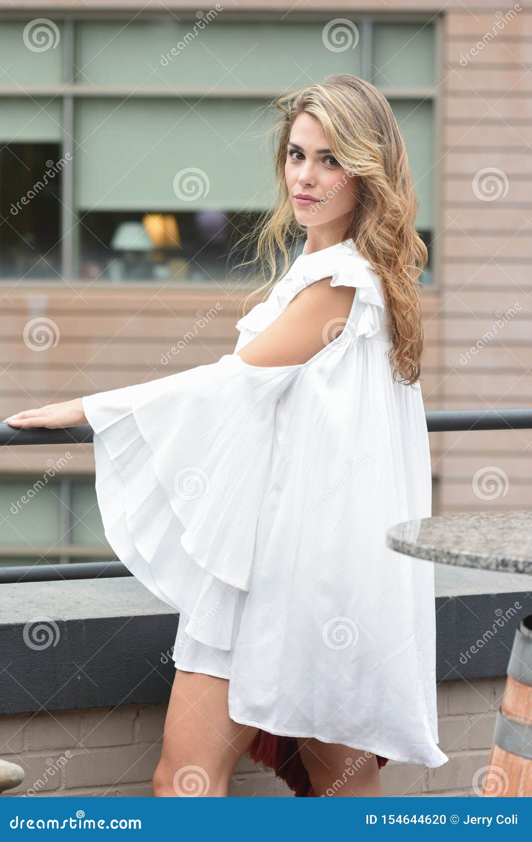 Blonde Female Model Posing by a Railing Stock Photo - Image of eyes ...