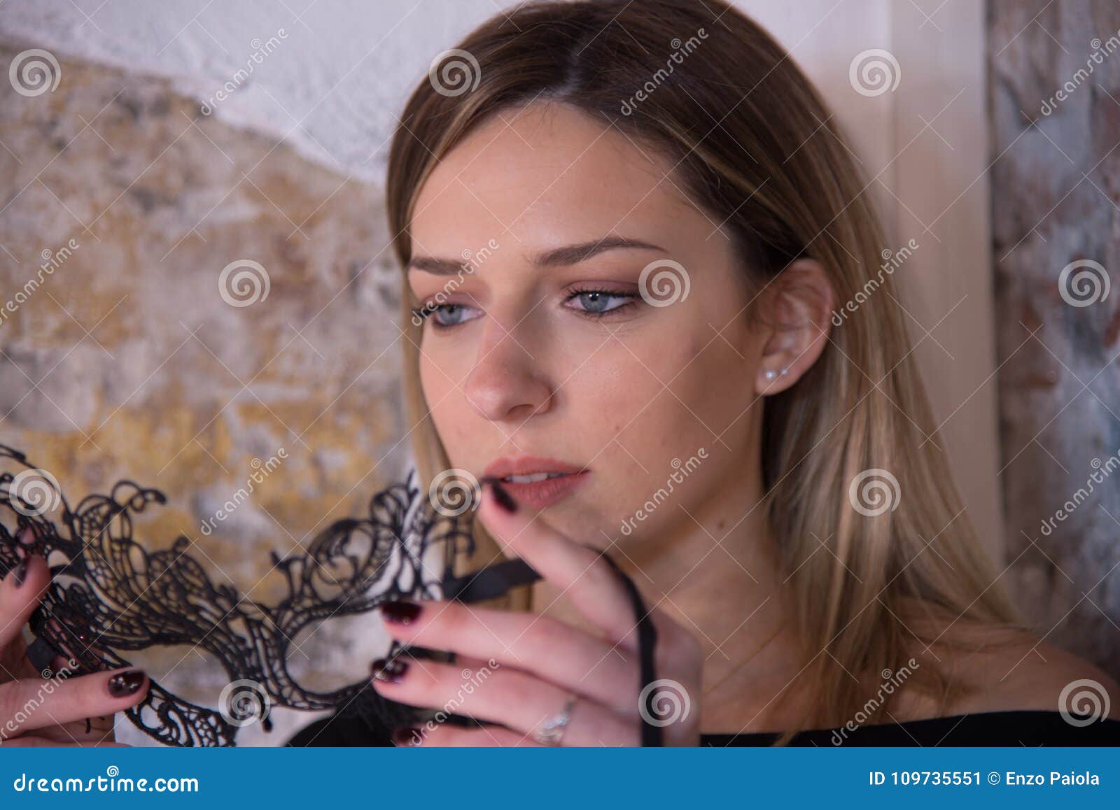 Blonde Girl With Black Carnival Mask Over White Background Masquerade