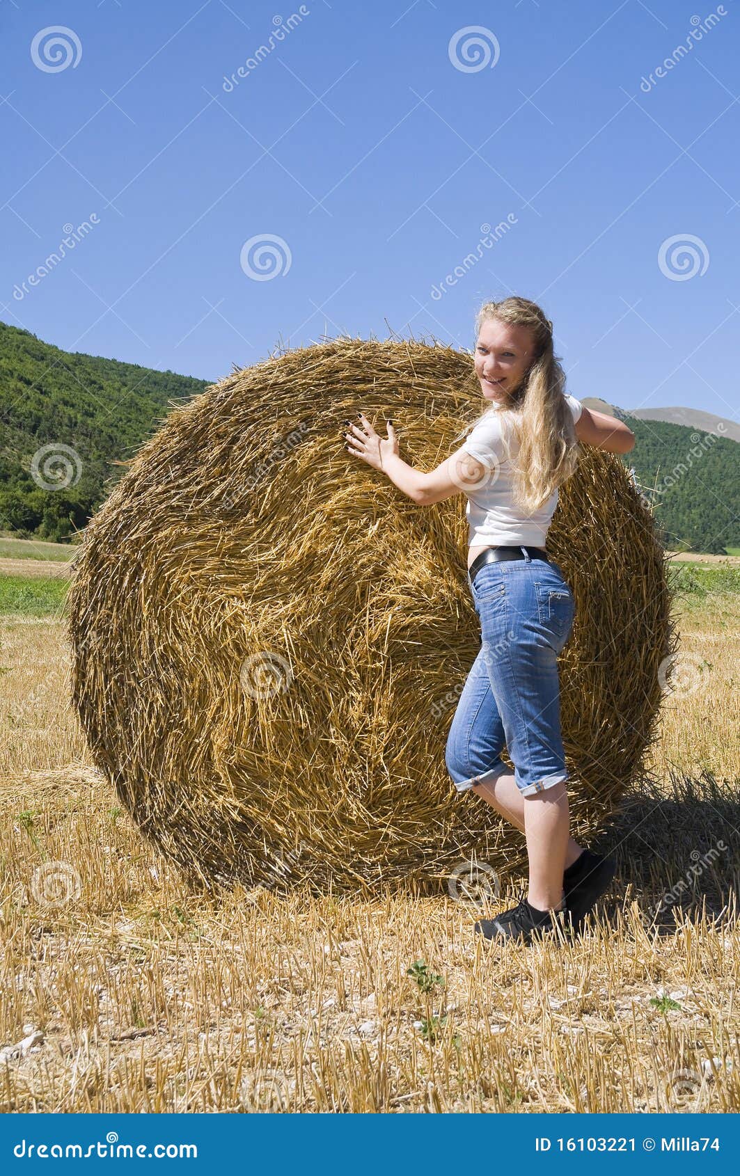Blonde Girl Leaning Against a Rolling Haystack. Stock Image - Image of ...