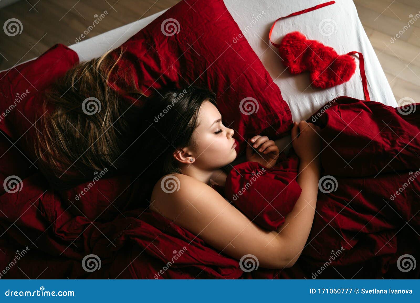 Blonde Girl With Long Hair Sleeping On A Red Bedding Pillow Stock Image