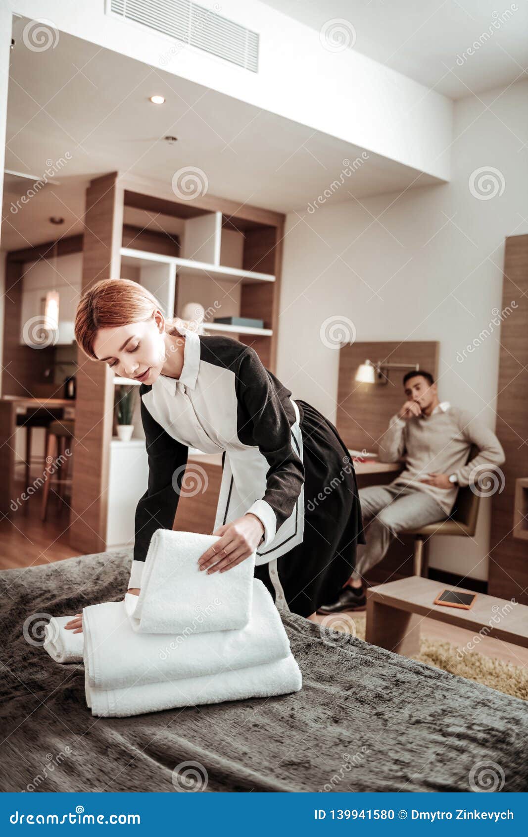Blonde-haired Housekeeper Wearing White and Black Uniform Working Stock ...