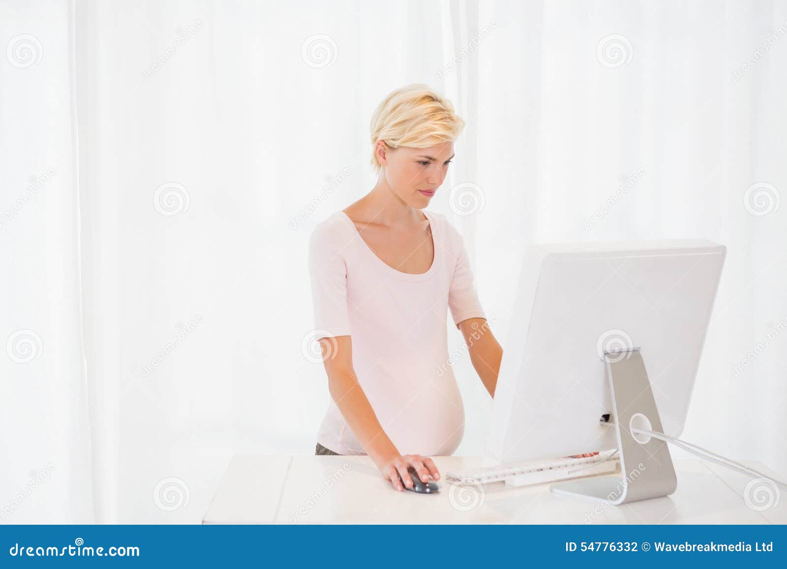 A Blonde Pregnant Using Computer Stock Photo - Image of clothing ...