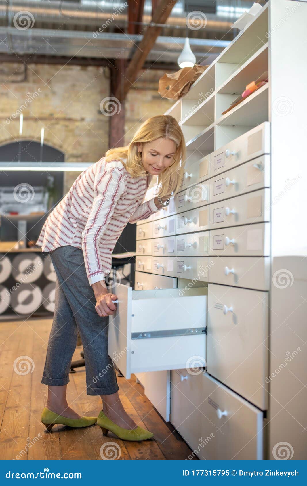 Blonde Woman Bending, Opening Drawer, Looking Inside Stock Image ...