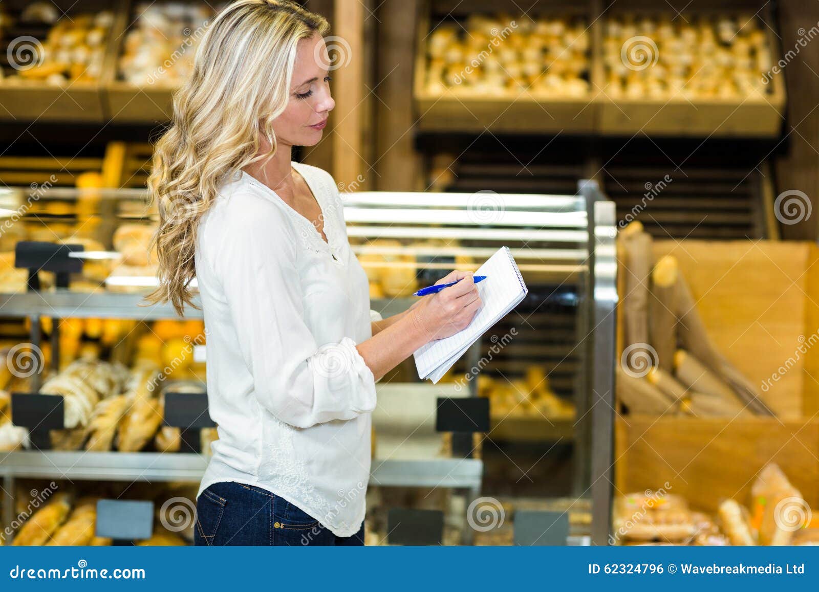 Blonde woman checking list stock photo. Image of market - 62324796