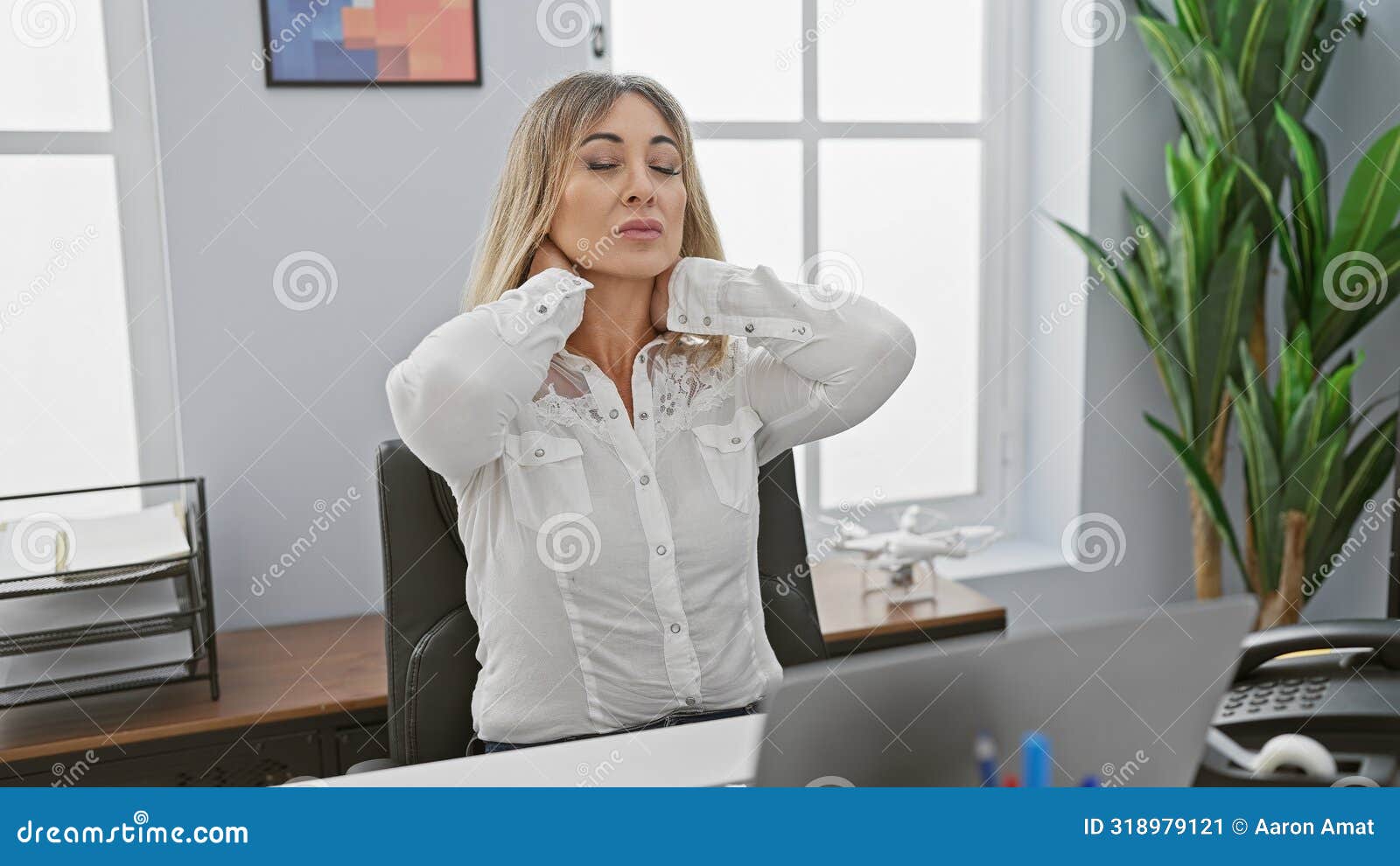 Blonde Woman in Office Experiencing Neck Pain while Working on Computer ...