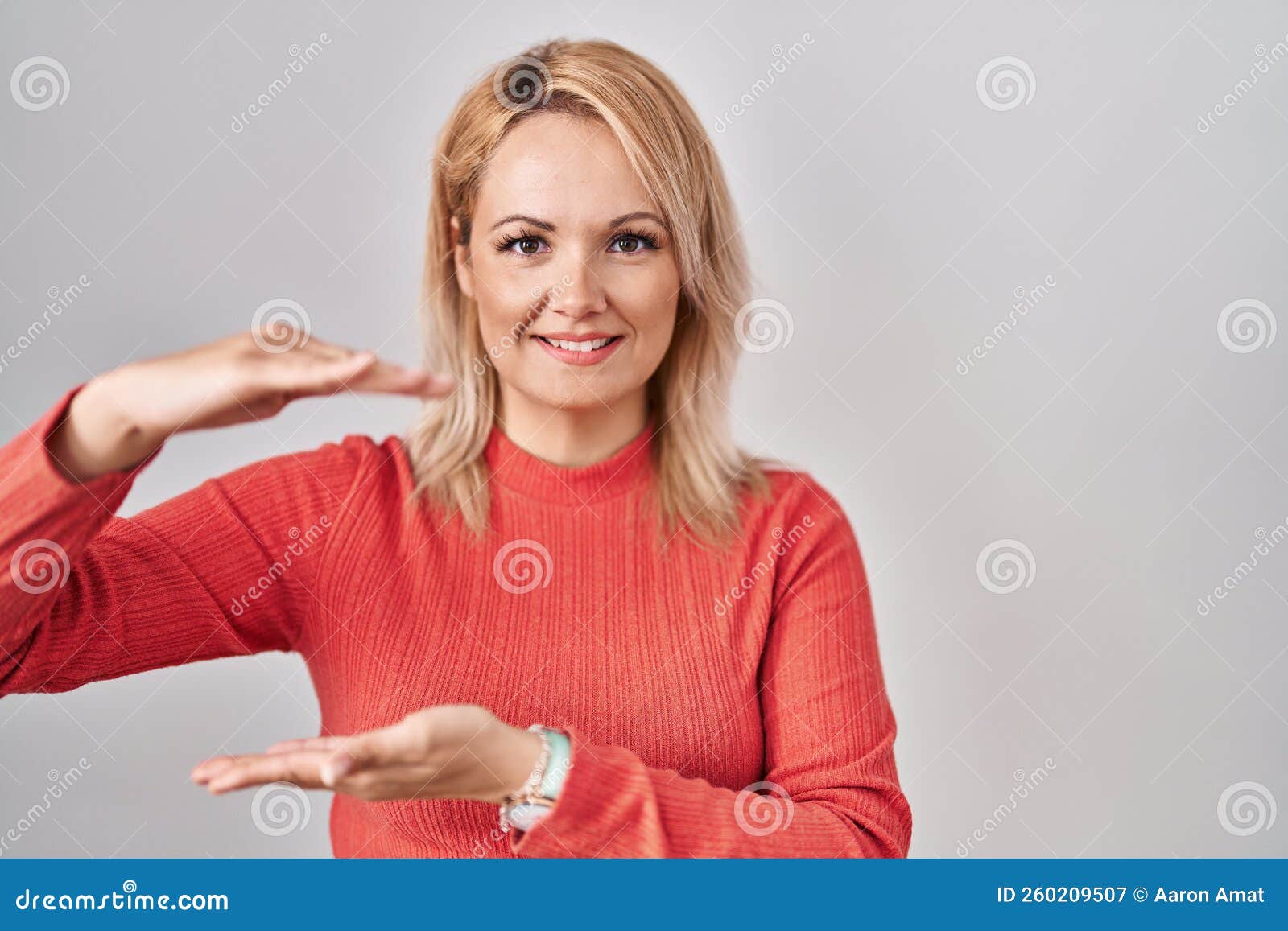 Blonde Woman Standing Over Isolated Background Gesturing With Hands