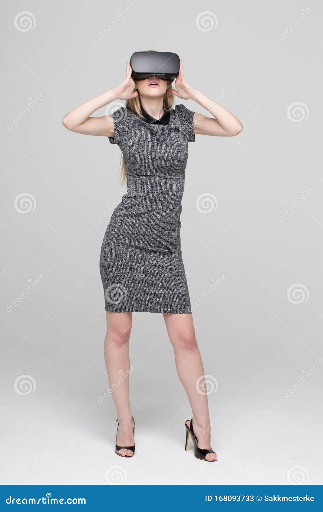 Blonde Woman Using VR Headset on Grey Background Full Body Stock Image ...
