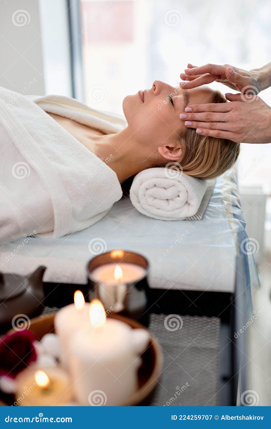 Young Blonde Woman Receiving Face And Head Massage In Spa Center Side