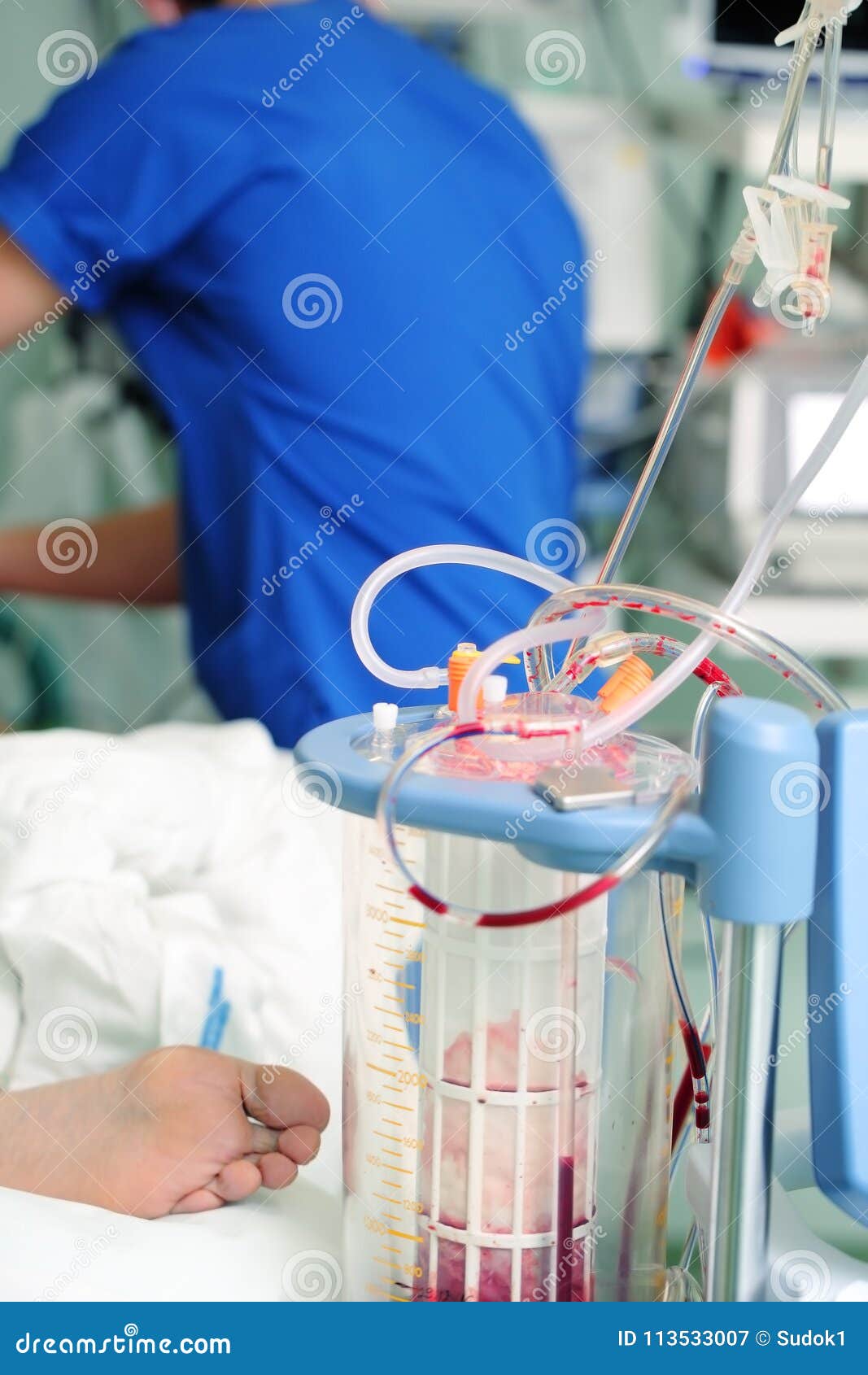 Blood Drain Container and Working Doctor Near the Patient Bed Stock ...