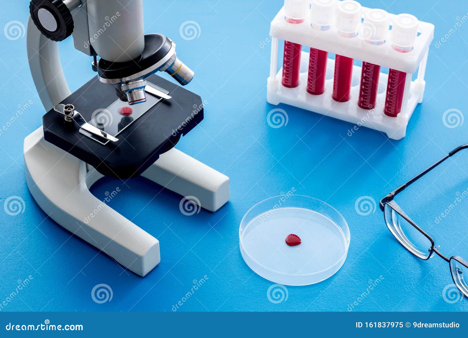 Blood Testing Laboratory. Samples Viewing Under Microscope Near Tubes ...