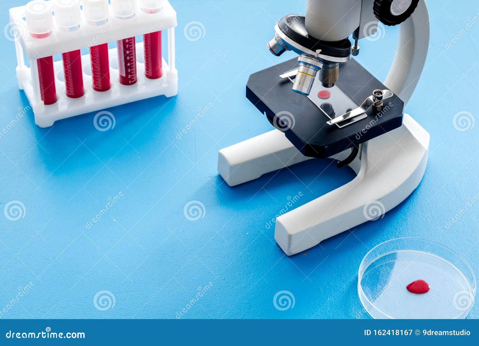 Blood Testing Laboratory. Samples Viewing Under Microscope Near Tubes ...
