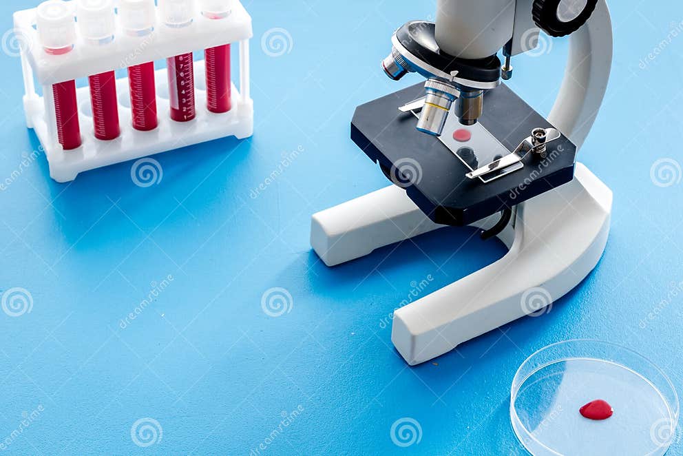 Blood Testing Laboratory. Samples Viewing Under Microscope Near Tubes ...