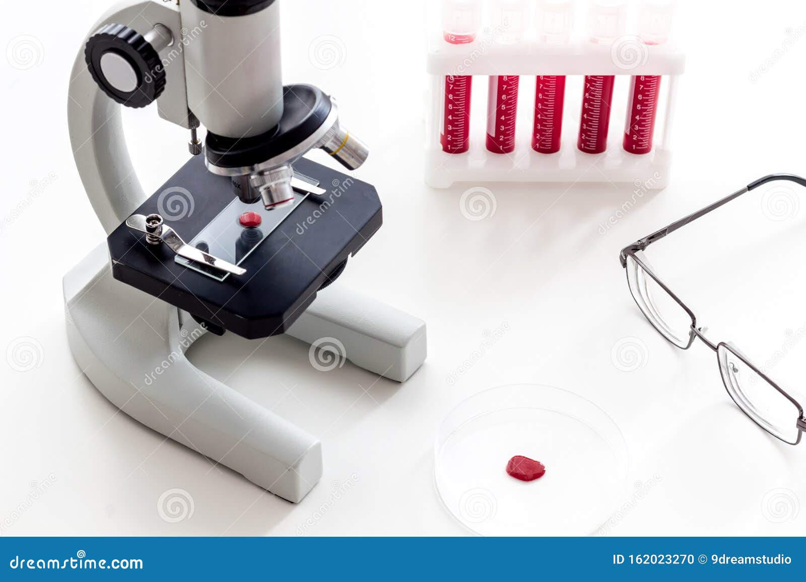 Blood Testing Laboratory. Samples Viewing Under Microscope Near Tubes ...