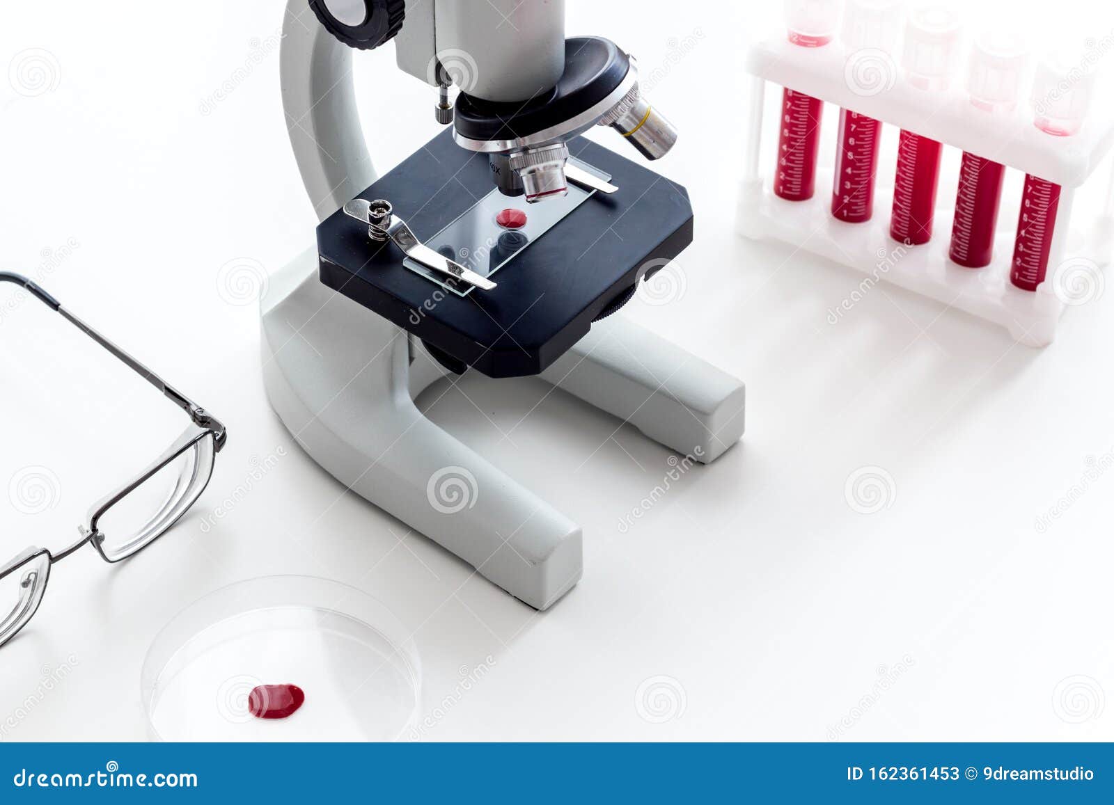 Blood Testing Laboratory. Samples Viewing Under Microscope Near Tubes ...