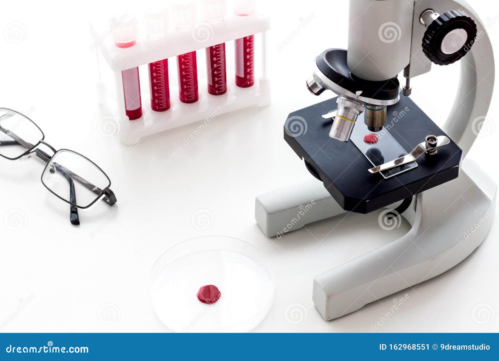 Blood Testing Laboratory. Samples Viewing Under Microscope Near Tubes ...